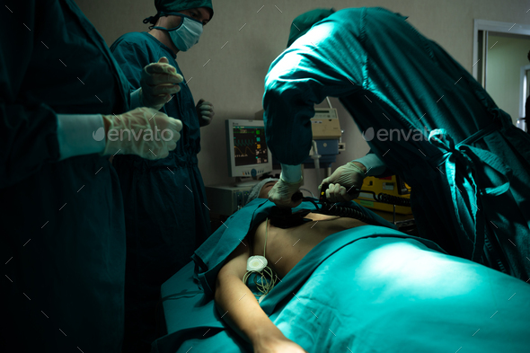 Medical team of surgeons in hospital doing invasive surgical ...