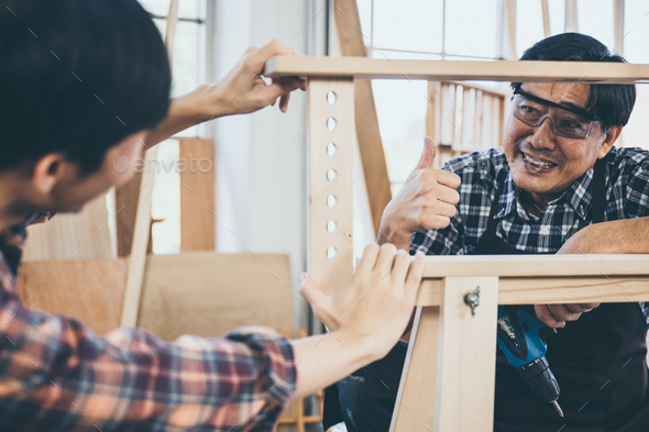 Craftsman carpenter team cooperating on building construction planning ...
