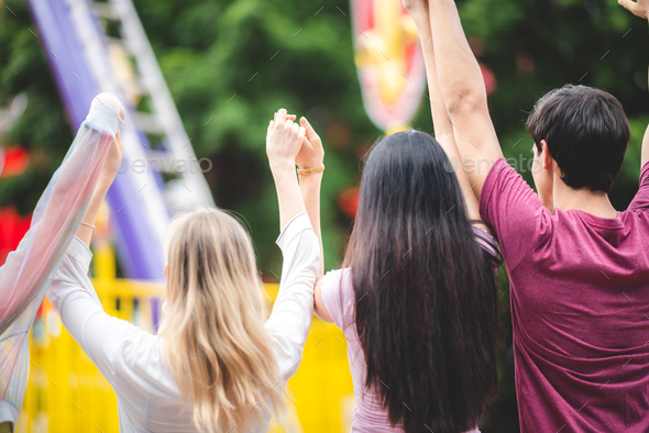 Group of happy best friends laughing and having fun at amusement park ...