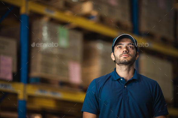 Portraits of male warehouse personnel staff wearing blue uniforms ...