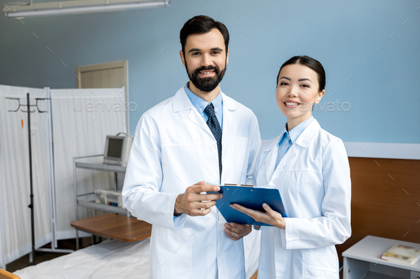 two doctors holding diagnosis and posing in hospital chamber Stock ...
