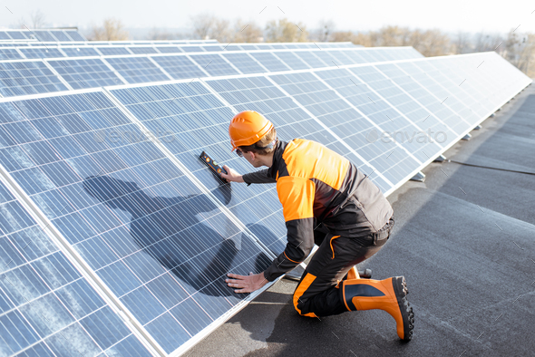 Worker installing solar panels Stock Photo by RossHelen | PhotoDune