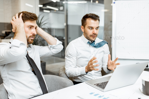 Exhausted employees working in the office Stock Photo by RossHelen