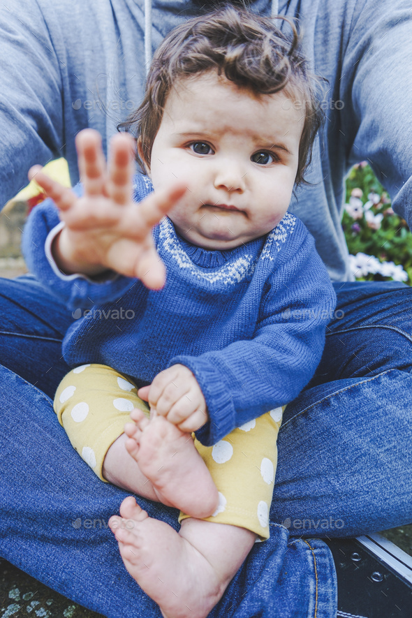 Little baby portrait sitting on his dad legs Stock Photo by nanihta