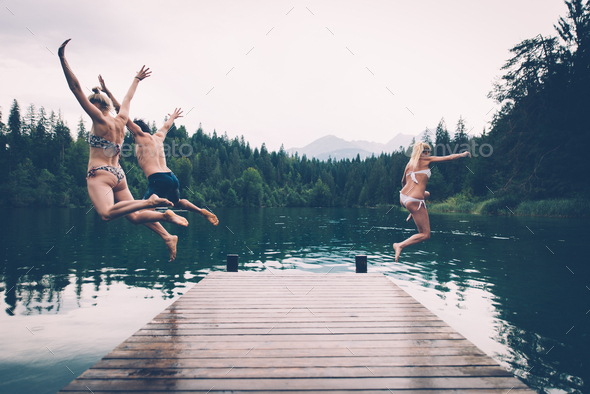 Group of friends having fun at the lake in the morning Stock Photo by ...