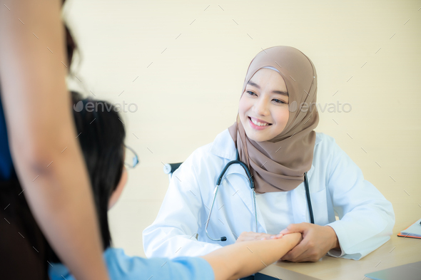 The beautiful Muslim doctor wear hijab works at the hospital to take ...