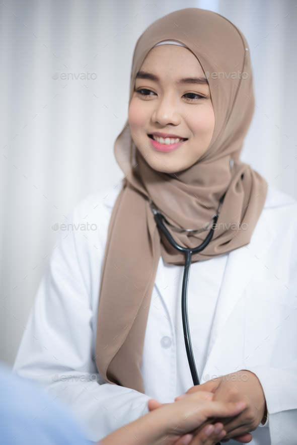 The beautiful Muslim doctor wear hijab works at the hospital to take ...