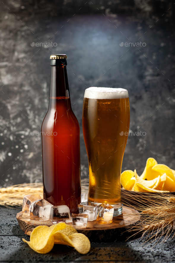 front view bottle of bear with glass full of bear on light background ...