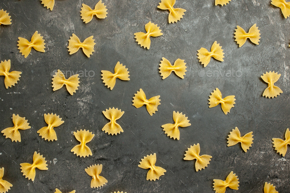 top view little raw pasta spread all over dark-grey background food ...
