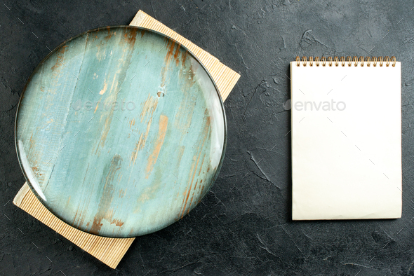 top view cyan round platter beige board notebook on black table Stock ...
