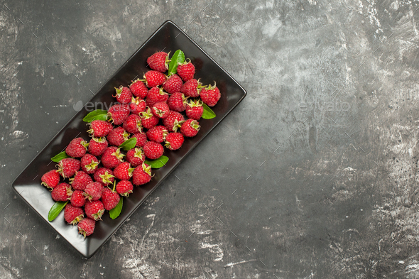 top view fresh red raspberries inside black pan on grey background ...