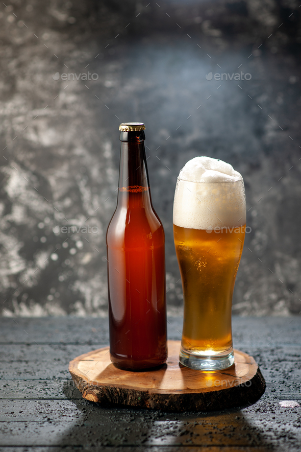 front view bottle of bear with glass full of bear on a light background ...