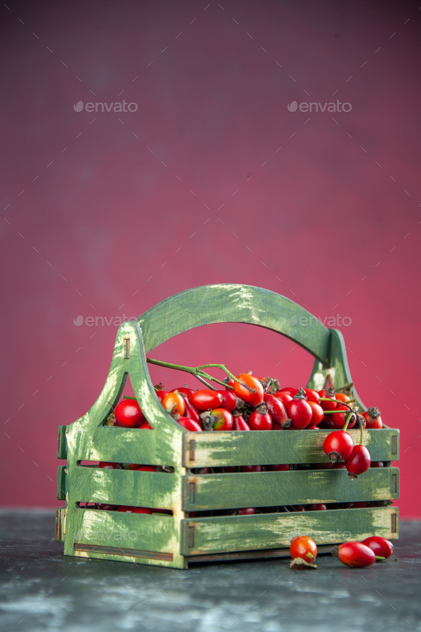 front view red berries inside little box on a pink background color ...