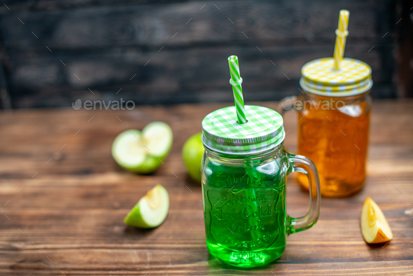 front view fresh juices inside glass cans with fruits on dark ...