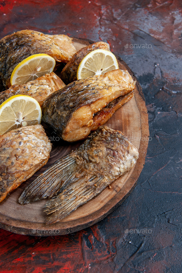 Top view placed left ( fish) decorated with lemon slices free space for ...