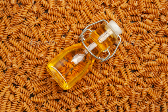 High resolution photo of fallen oil bottle of raw Italian pasta in ...