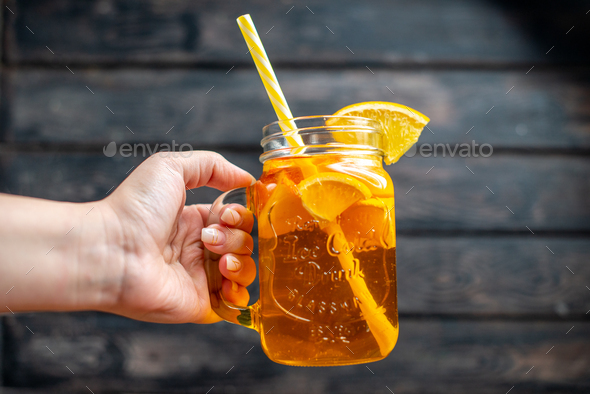 front view fresh orange juice inside can on dark background bar fruit ...