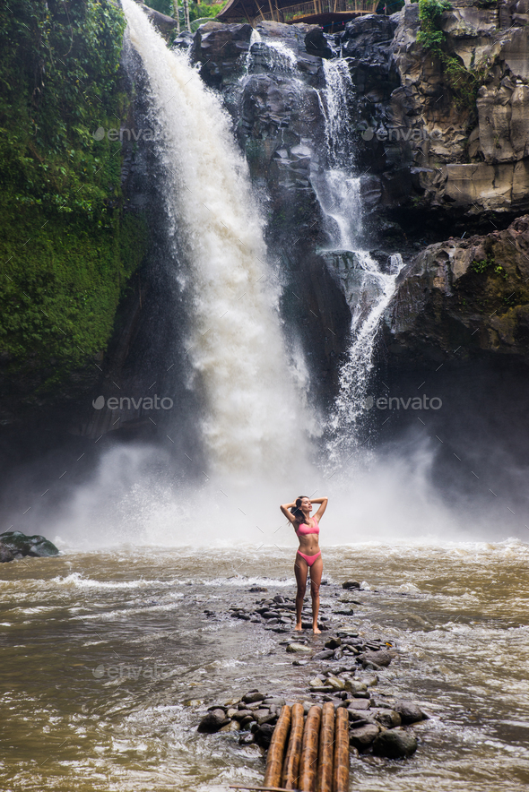 Pretty girl at Tegenungan Waterfall, Bali Stock Photo by oneinchpunchphotos