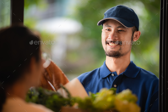 The delivery man staff are delivering fresh food to customers at home ...
