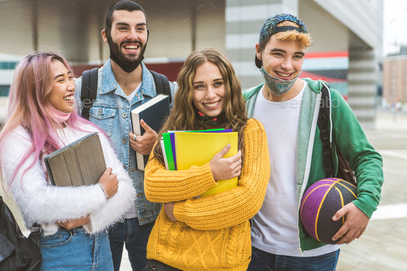 Group of young students bonding outdoors Stock Photo by oneinchpunchphotos