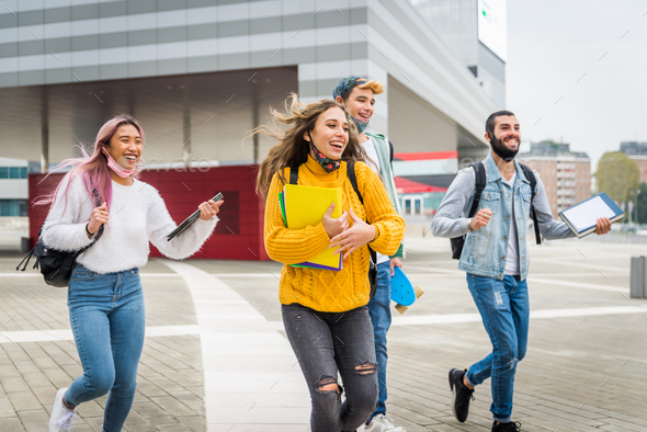 Group of young students bonding outdoors Stock Photo by oneinchpunchphotos