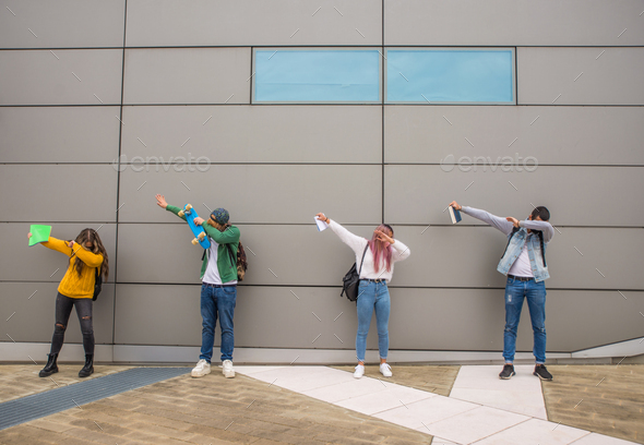 Group of young students bonding outdoors Stock Photo by oneinchpunchphotos