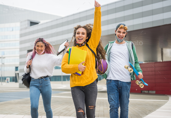 Group of young students bonding outdoors Stock Photo by oneinchpunchphotos