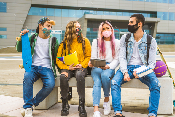 Group of young students bonding outdoors Stock Photo by oneinchpunchphotos
