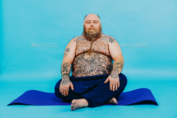 Funny fat man doing yoga meditation Stock Photo by oneinchpunchphotos