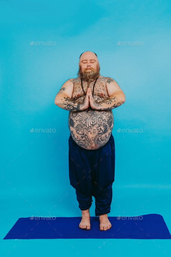Funny fat man doing yoga meditation Stock Photo by oneinchpunchphotos