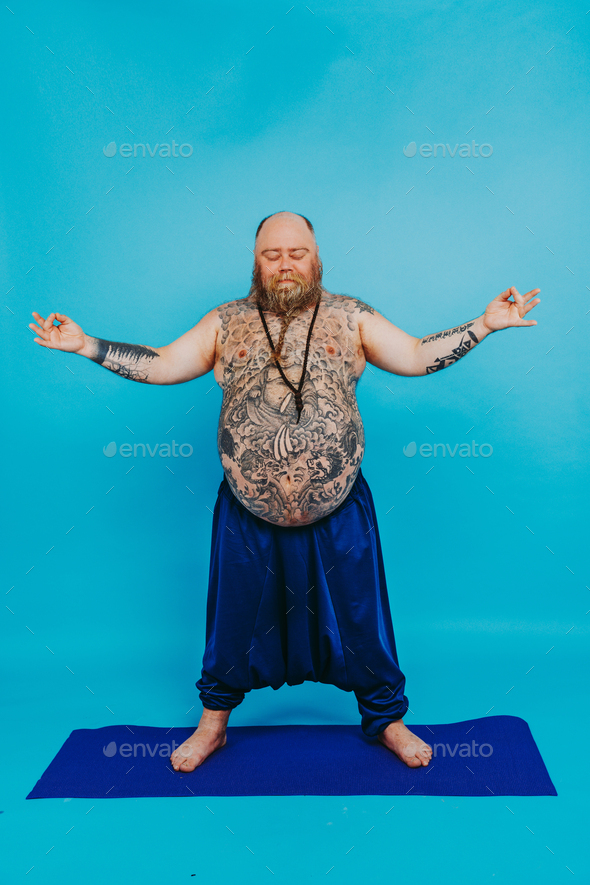 Funny fat man doing yoga meditation Stock Photo by oneinchpunchphotos