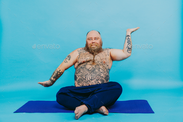 Funny fat man doing yoga meditation Stock Photo by oneinchpunchphotos