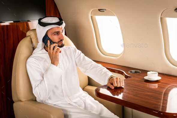Arabian man wearing kandora flying on private jet Stock Photo by ...