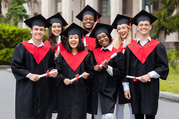Diverse international students with diplomas celebrating graduation ...