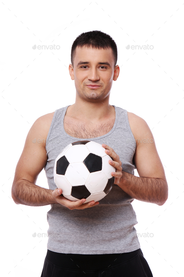 Attractive guy holding soccer ball Stock Photo by Microstock_Growth