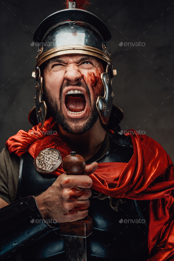 Roman warrior screaming looking up in dark background Stock Photo by ...
