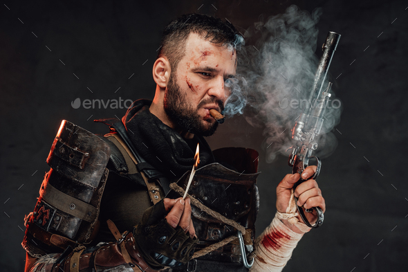 Serious apocalyptic fighter smoking cigar and holding gun Stock Photo ...