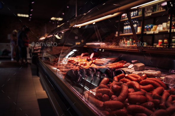 Sideview of a stylish butcher shop and its fridged counter with meat ...