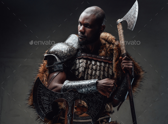 Northern african chief with fur wielding dual axes in dark background ...