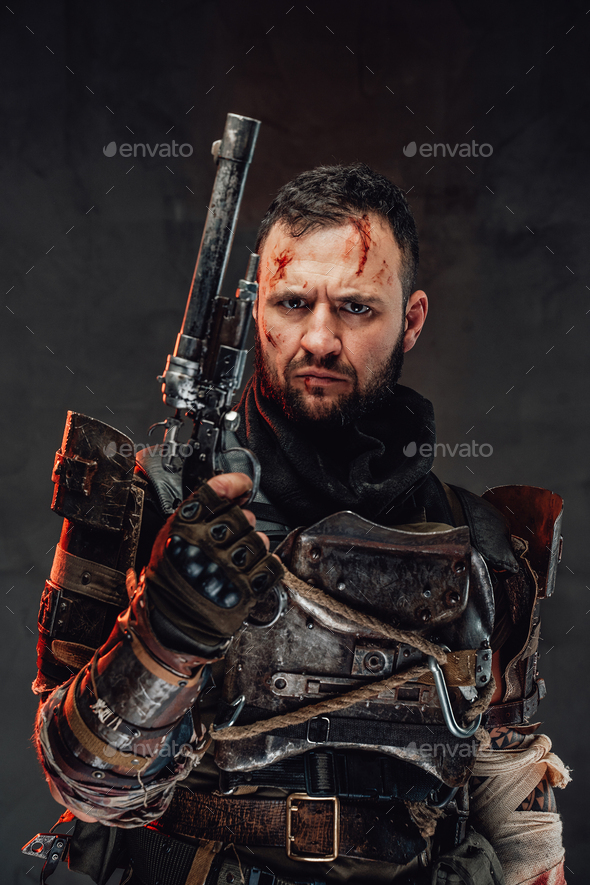 Bearded survivor after apocalypse poses with pistol Stock Photo by fxquadro