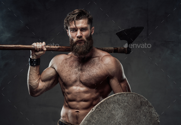 Muscular viking with axe and shield in dark smoke background Stock ...