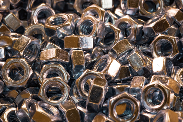 Metal chrome nuts in a chaotic order industrial background Stock Photo ...