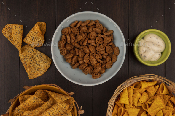 top view of crispy tasty rye rusks on a bowl with spicy chips on a ...