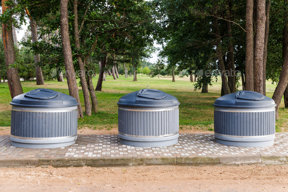 Modern trash cans round containers in park for separate collection of ...