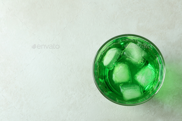 Glass of green soda on white textured background Stock Photo by ...