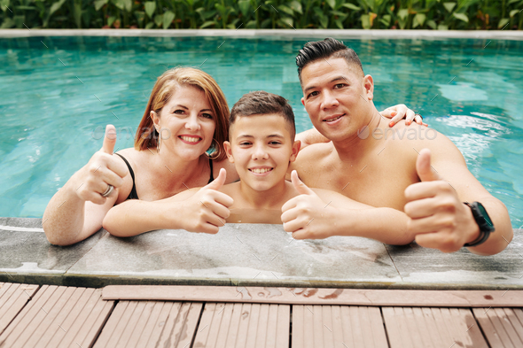 Cheerful family in swimming pool Stock Photo by DragonImages | PhotoDune