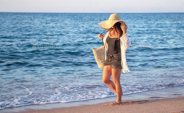 Beautiful boho model in a hat with a wicker bag on the beach Stock ...