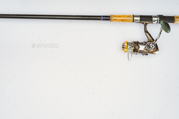 elevated view of fishing rod isolated on white, minimalistic concept ...