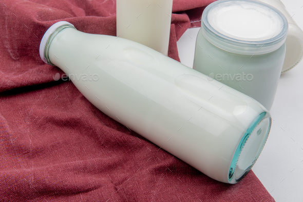 side view of milk products as milk, cream and sour clotted milk on ...