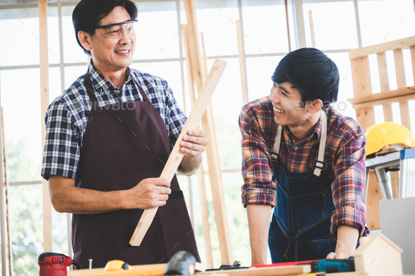 professional carpenter team work in construction with wood workshop ...